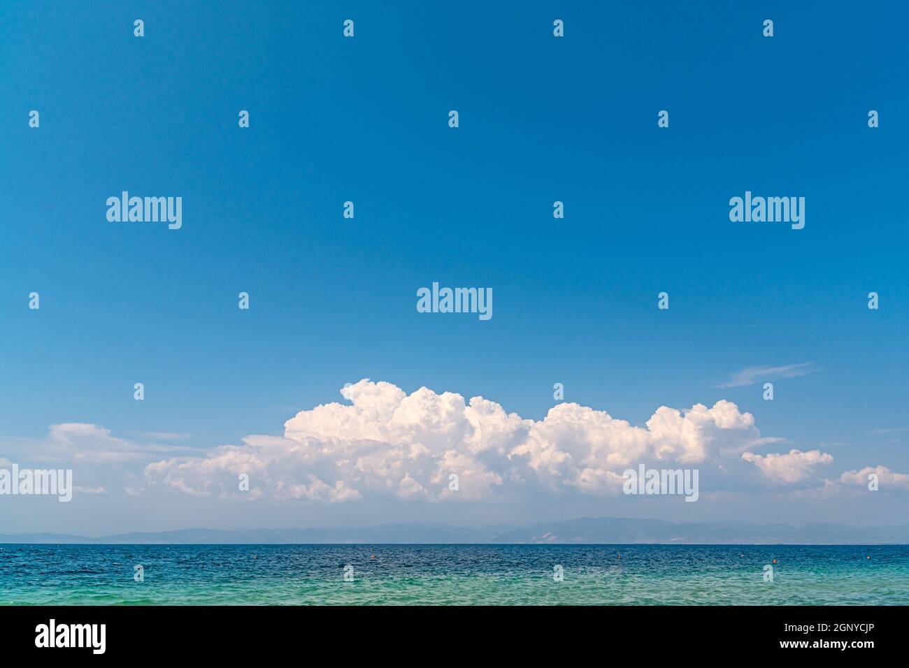 Sea and big blue sky with one big white cloud Stock Photo - Alamy