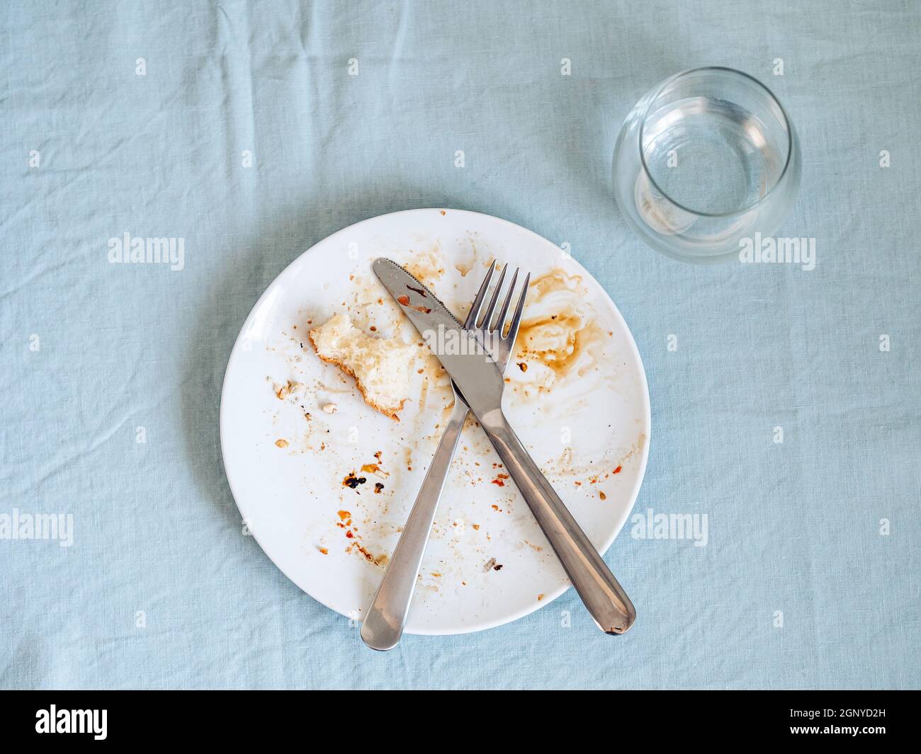 dirty plate after eating on the dining table. Top view of dirty white ...
