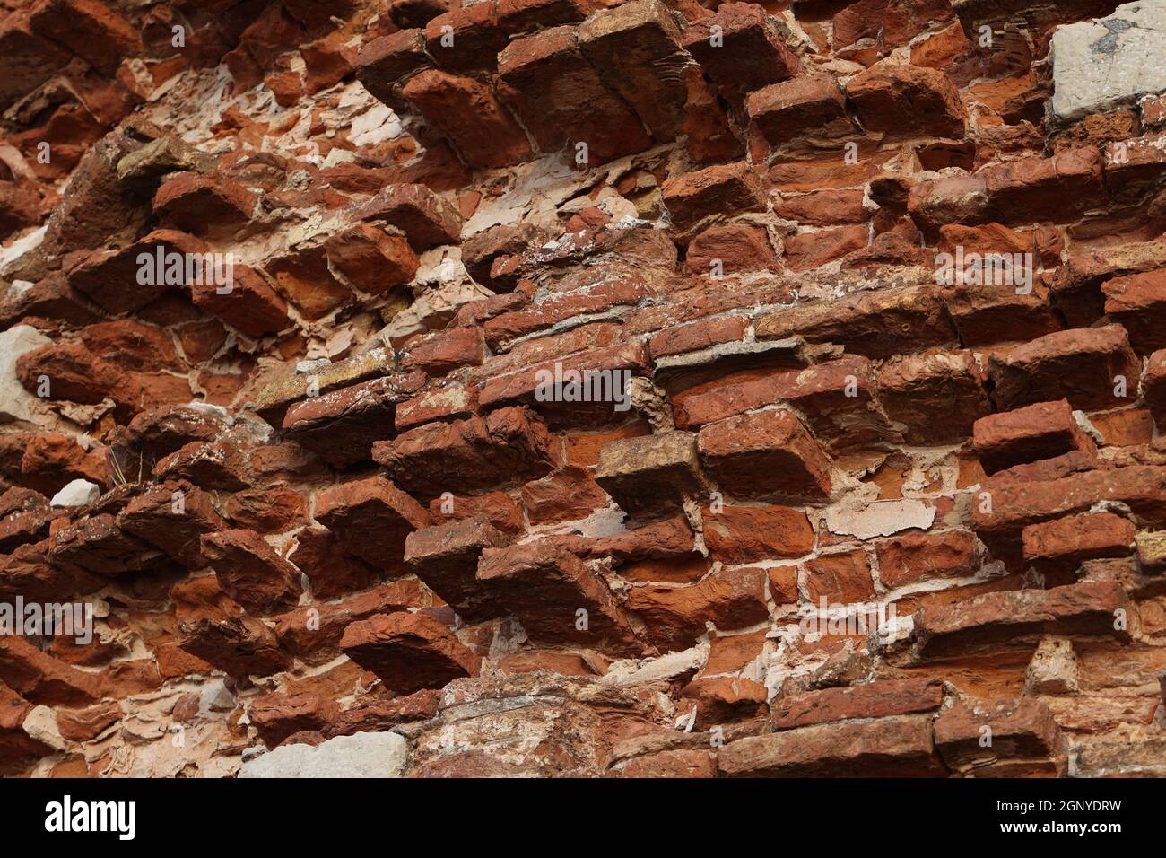 The old red brick fortress wall is crumbling Stock Photo - Alamy