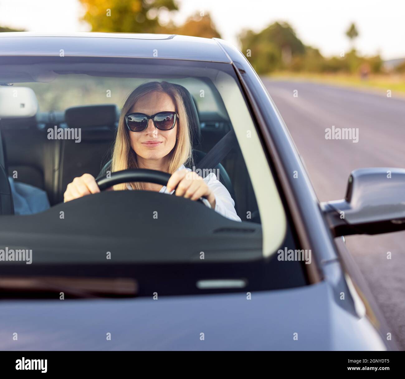 Confident woman driving car Stock Photo - Alamy