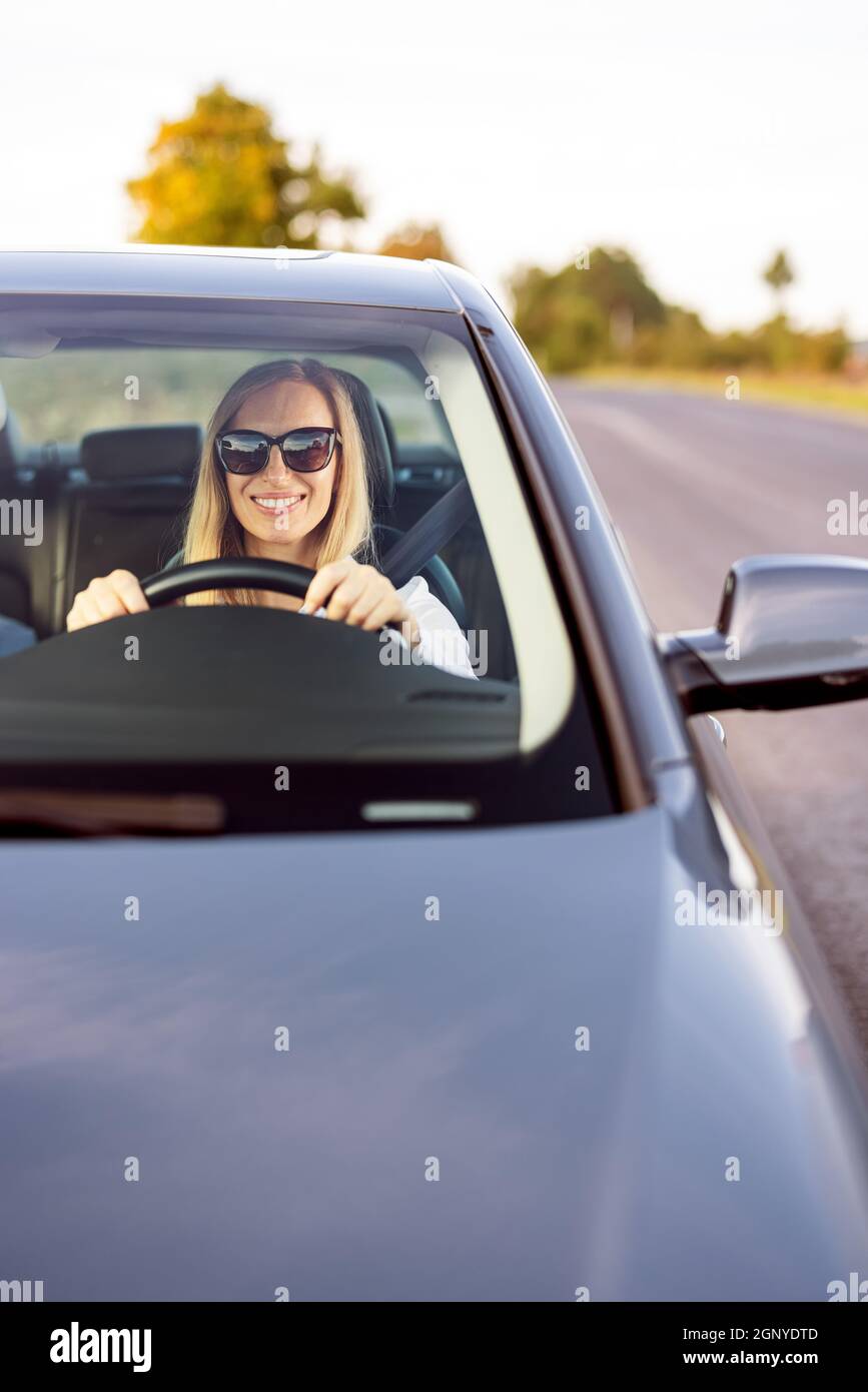 Happy woman driving car Stock Photo - Alamy