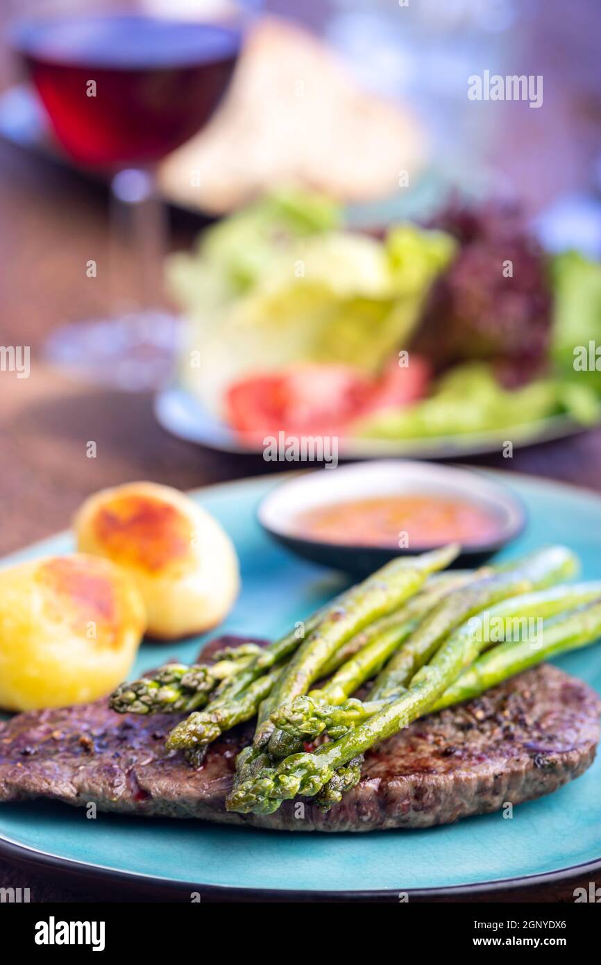 green asparagus on a steak Stock Photo - Alamy