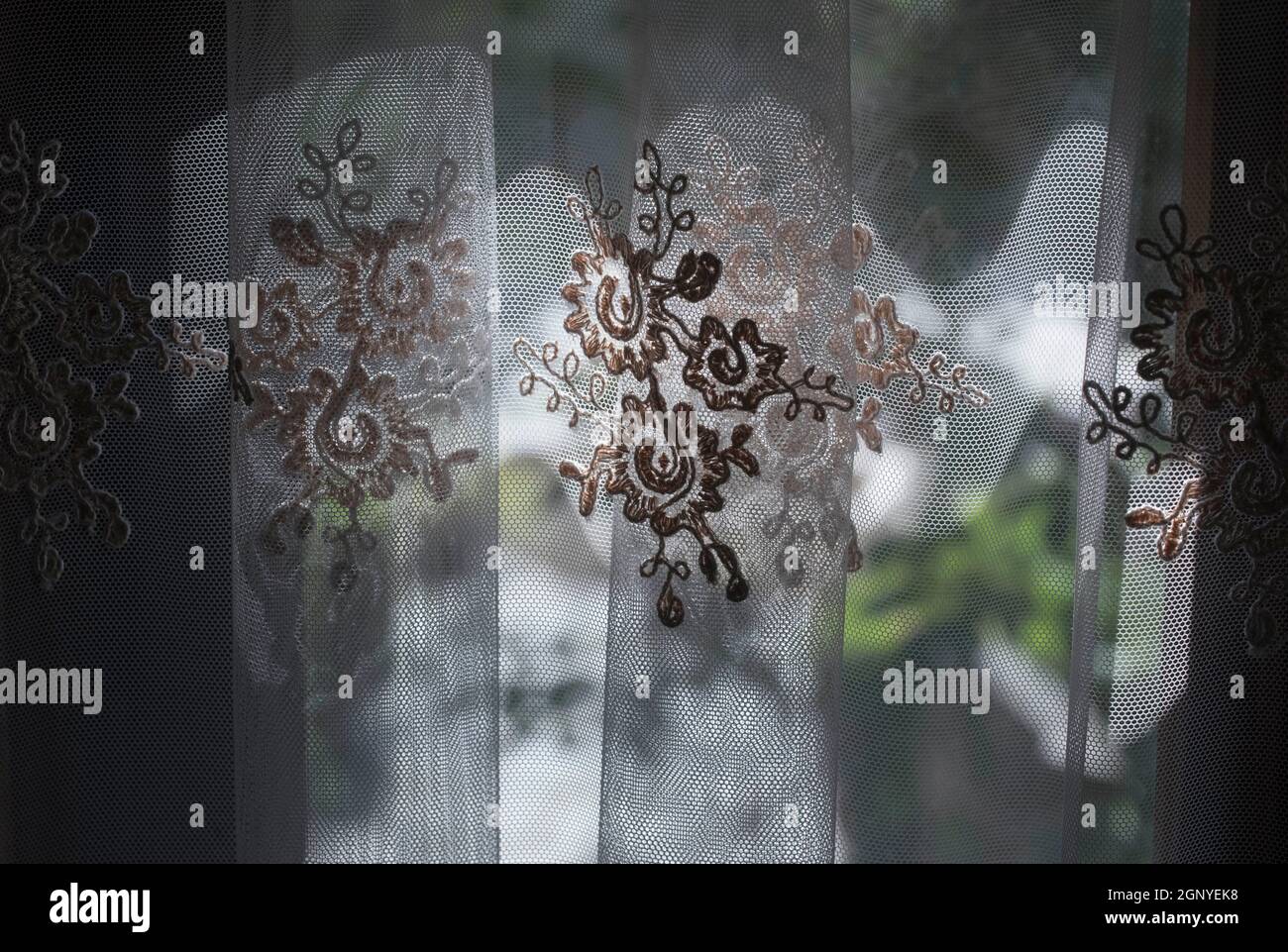 a curtain as visual protection in front of a window Stock Photo - Alamy
