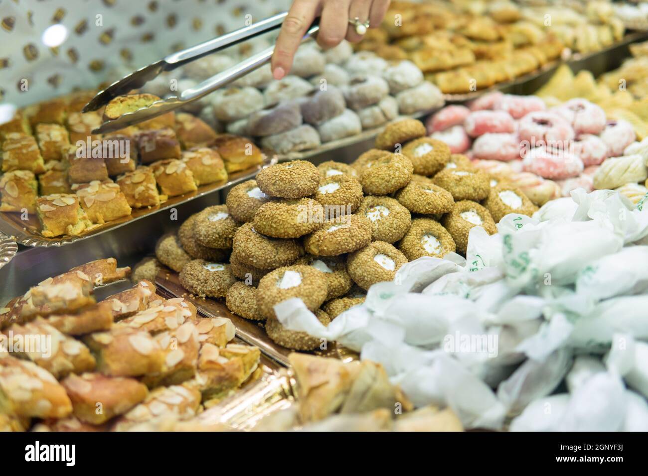 Hand of a woman picking up Homemade Moroccan pastries displayed Stock ...