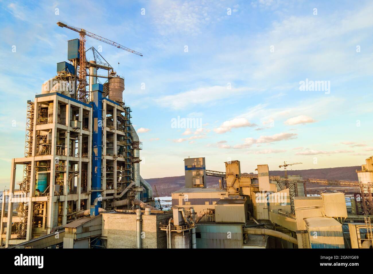 Aerial view of cement plant with high factory structure and tower crane ...