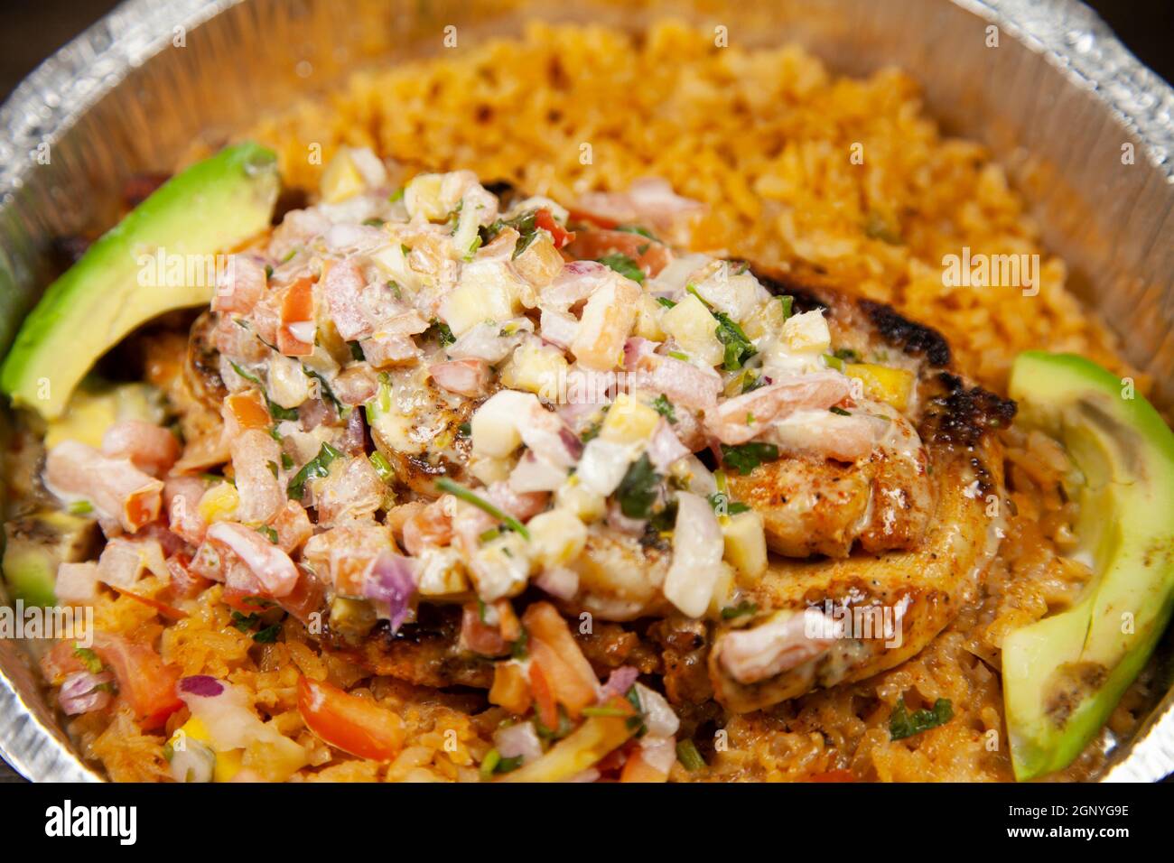 Baked chicken and shrimp over rice, smothered in a mango salsa with ...