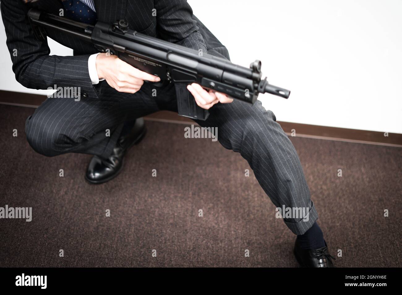 Businessman to fight with a machine gun. Shooting Location: Tokyo ...