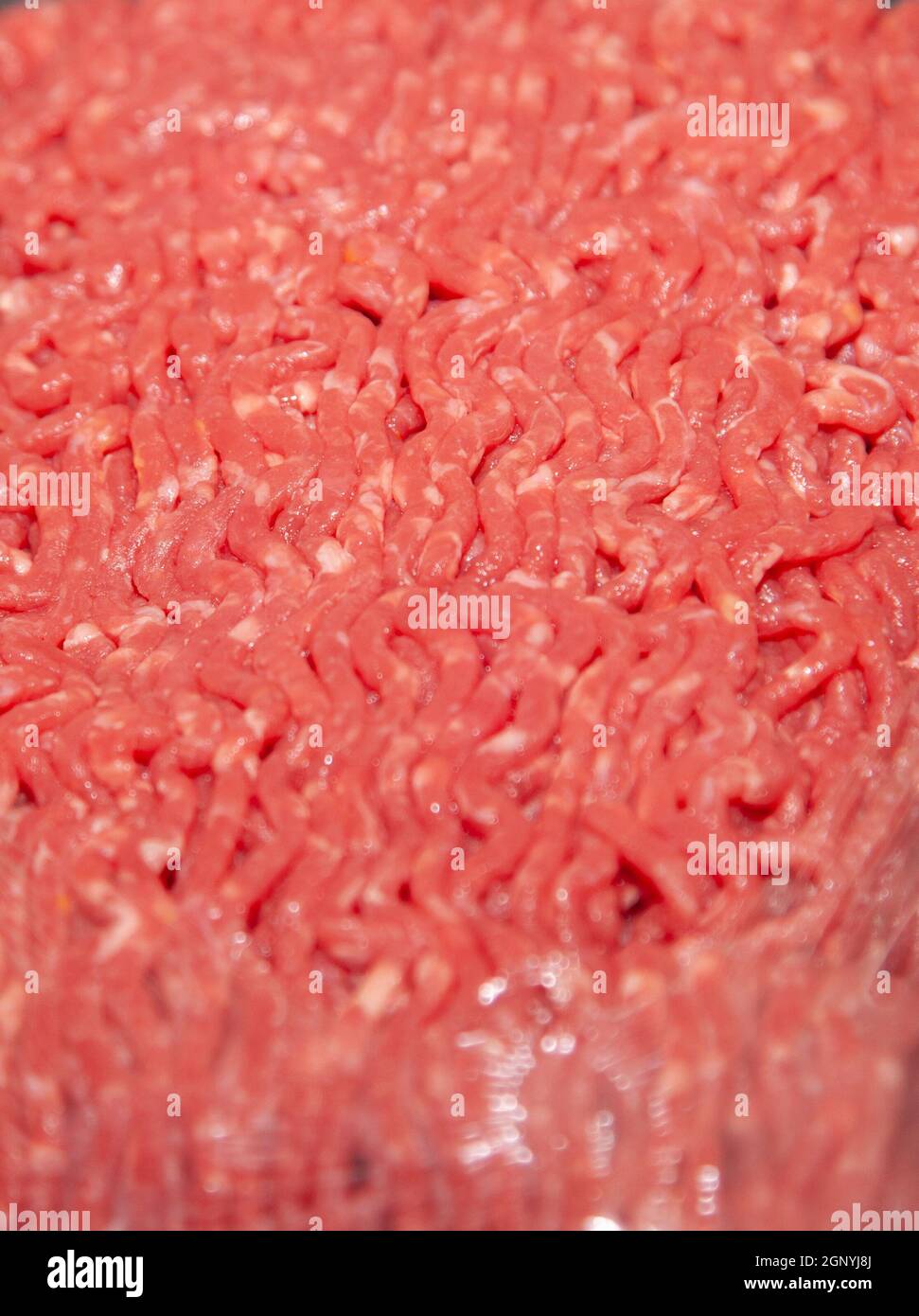Woman opening a package of angus ground beef Stock Photo - Alamy