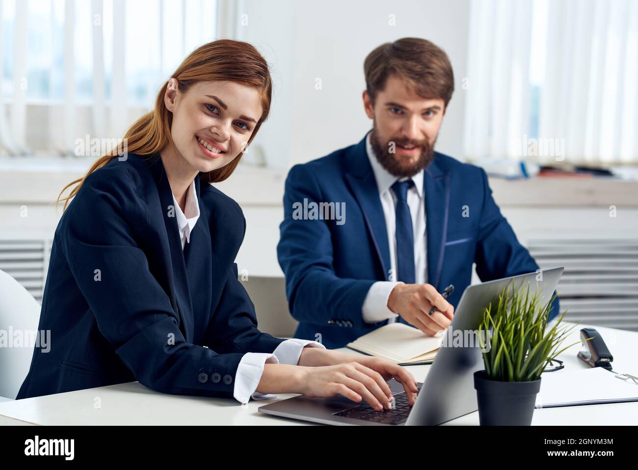 man and woman managers work together in front of laptop office ...