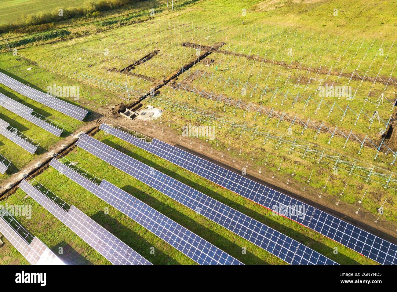 Aerial view of solar power plant under construction on green field ...