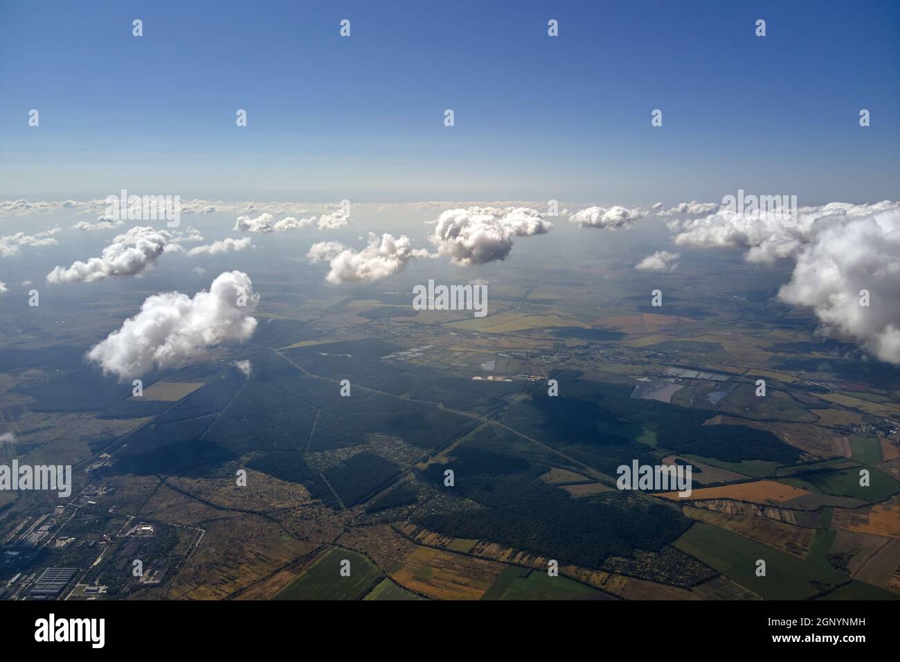 Aerial view from airplane window at high altitude of earth covered with ...