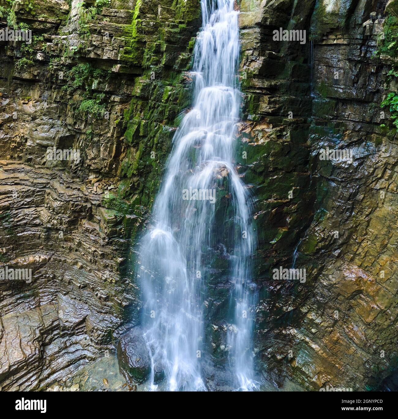 Waterfall on mountain river with white foamy water falling down from ...
