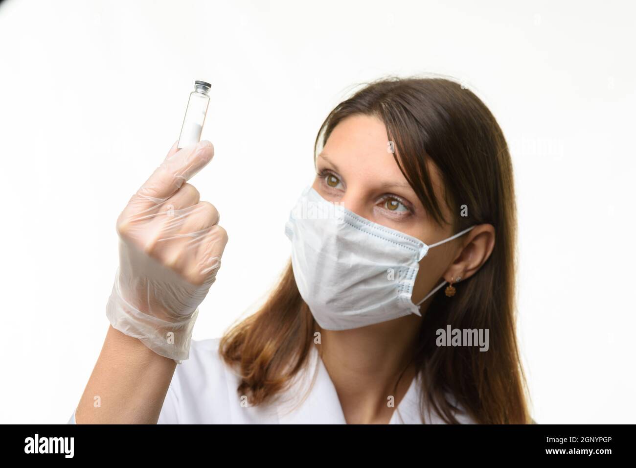 Girl doctor look at glass test tube with white powder, focus on test ...