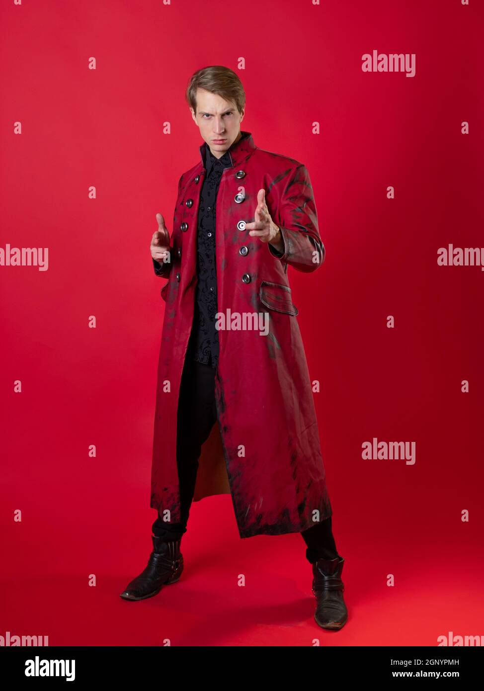 An outrageous young man in a daring red coat in a vintage noir style ...