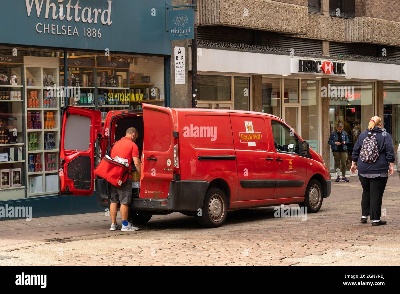 Royal Mail delivery van with postman sorting his post at the back of ...