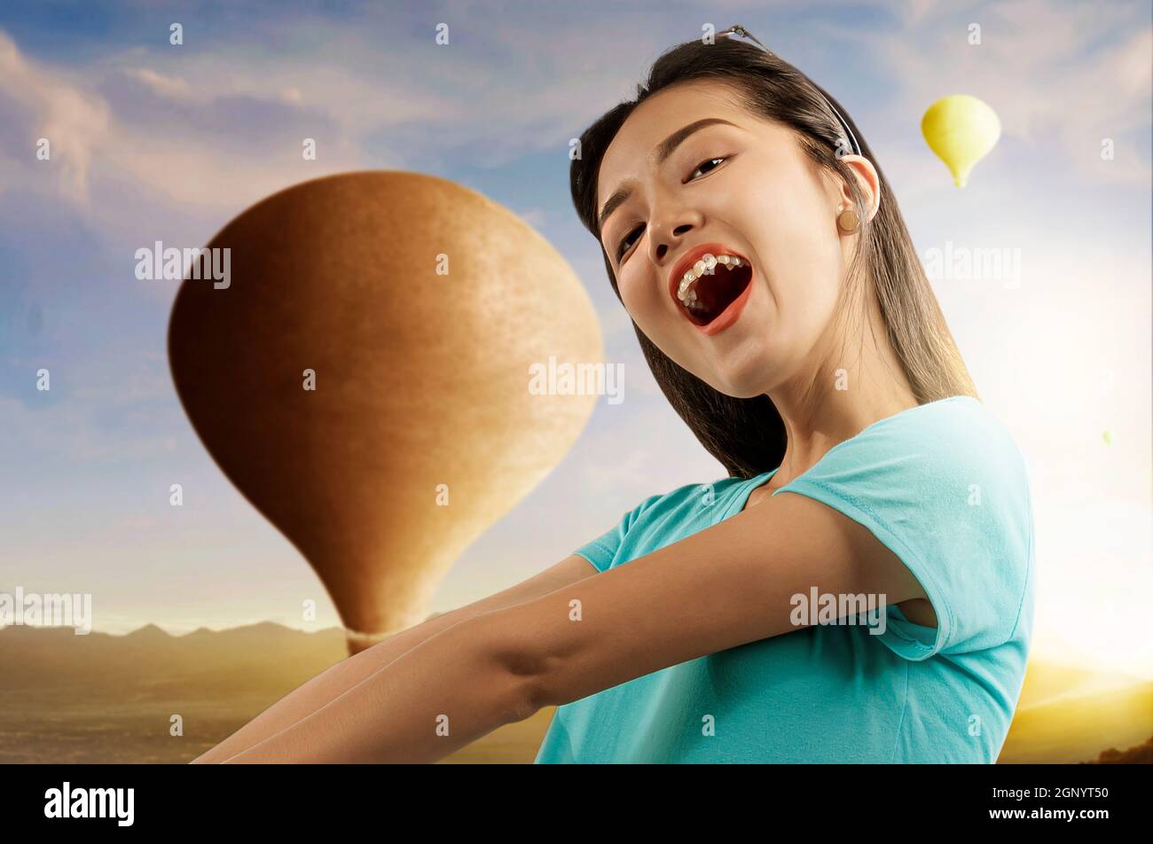 Asian woman with colorful air balloon flying with sunset sky background ...