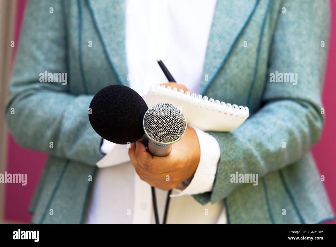Female journalist or TV reporter at news event. Journalism concept ...