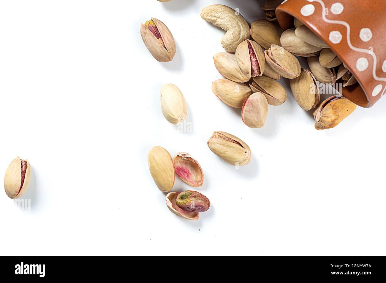 Pistachio and Cashew Nuts in clay pots on white background Stock Photo ...