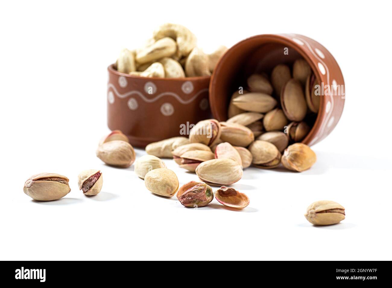 Pistachio and Cashew Nuts in clay pots on white background Stock Photo ...