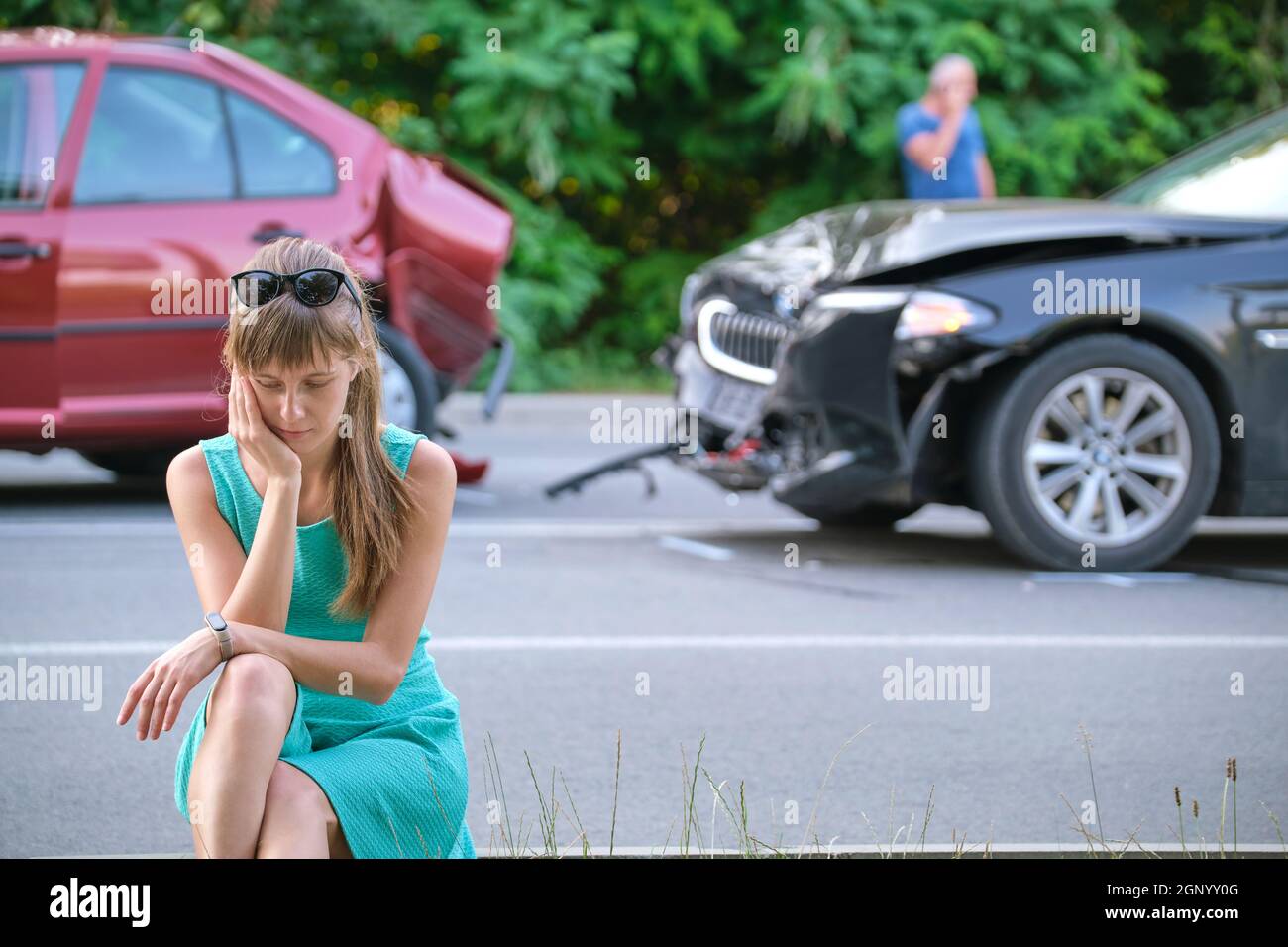 Stressed woman driver sitting on street side shocked after car accident ...