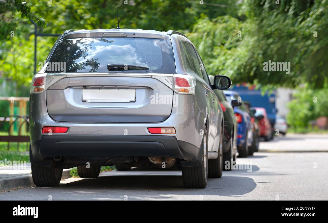 City traffic with cars parked in line on street side. Vehicle parking ...