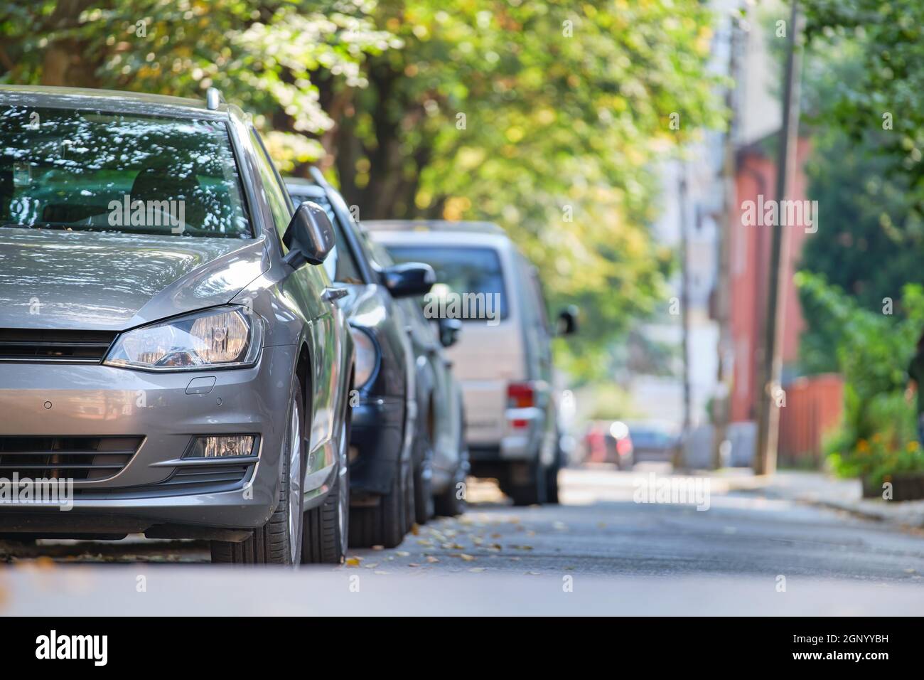 City traffic with cars parked in line on street side Stock Photo - Alamy