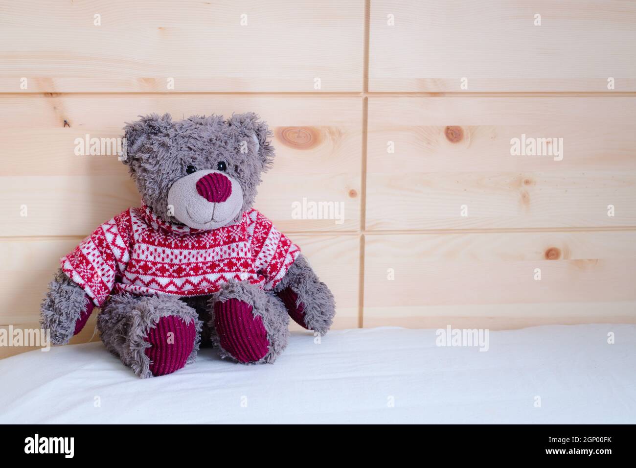 Cute teddy bear toy is sitting in the bed, wakeup at morning Stock ...