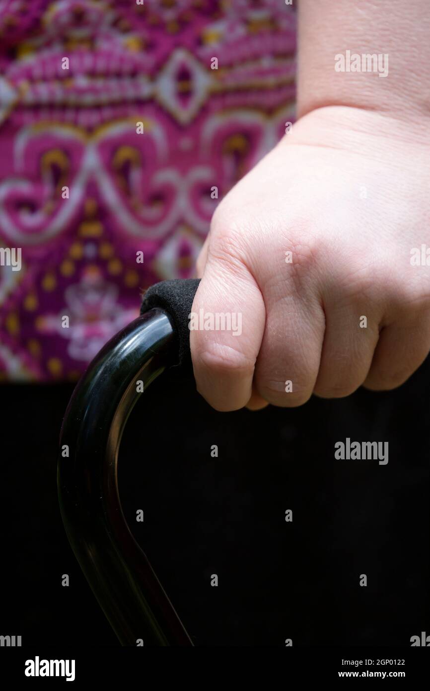 Close up of a woman's hand wrapped around a black cane Stock Photo - Alamy