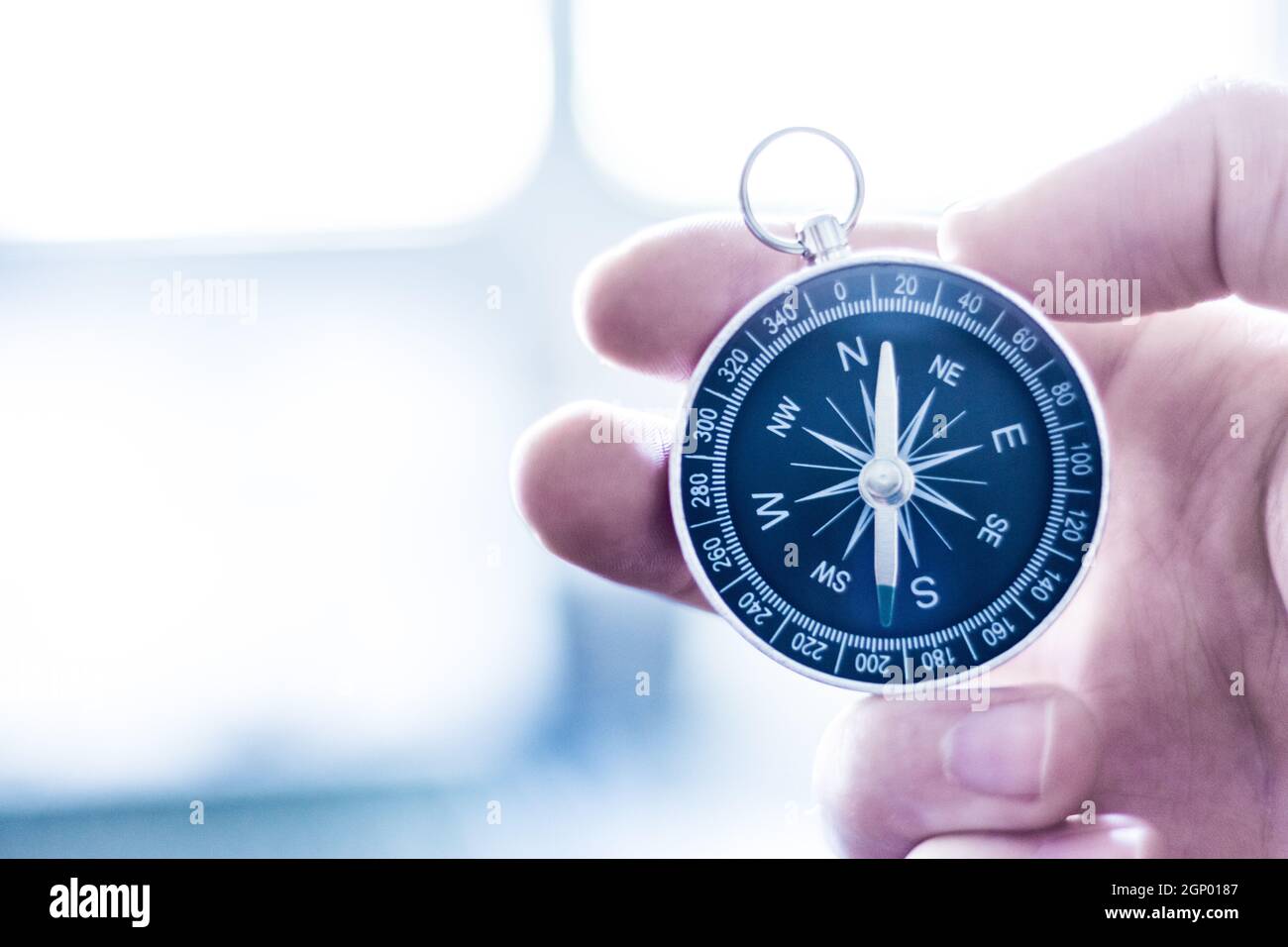 Closeup of a mans hand holding a compass in his hand. Concept for ...