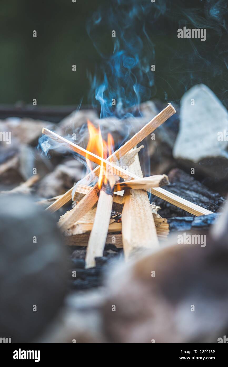Making fire in the wood, camping outdoors Stock Photo - Alamy