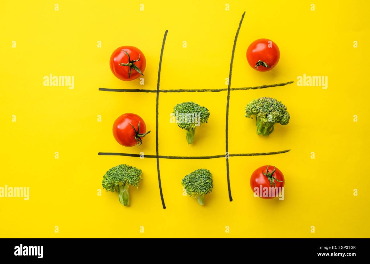 Vegetable cross-zero game isolated on yellow background. Organic ...