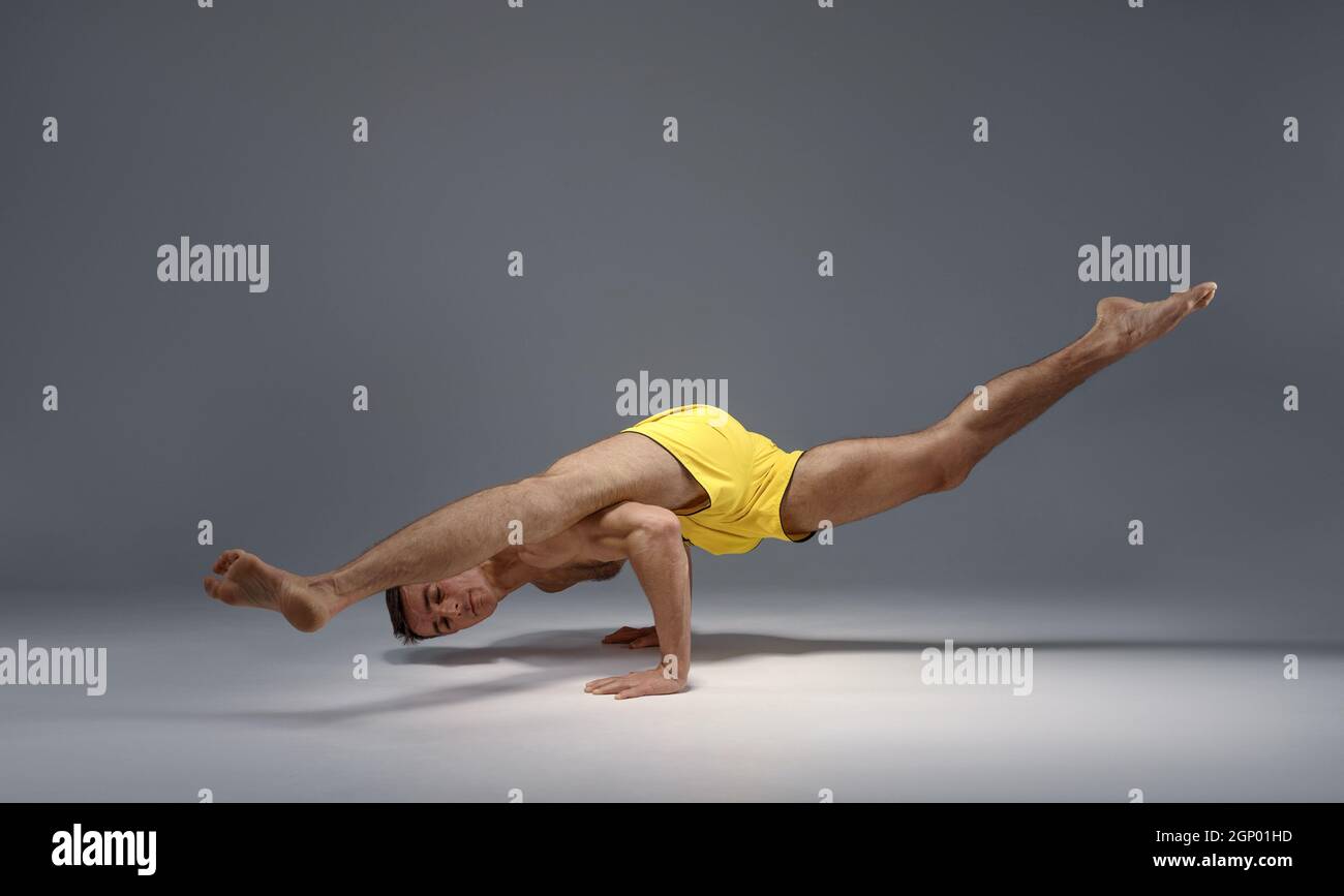 Muscular yoga stands on hands in difficult pose, meditation position ...