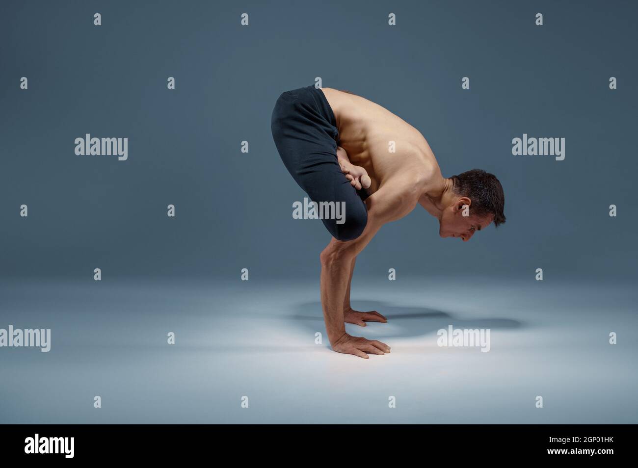 Muscular yoga keeps balanc on hands in difficult pose, meditation ...