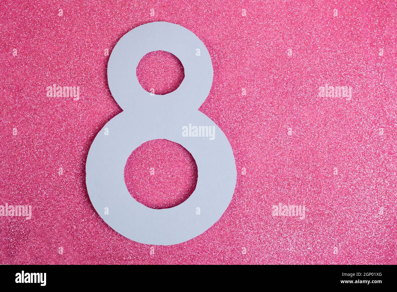 Number Eight cutted in paper against pink glitter background. Good for ...