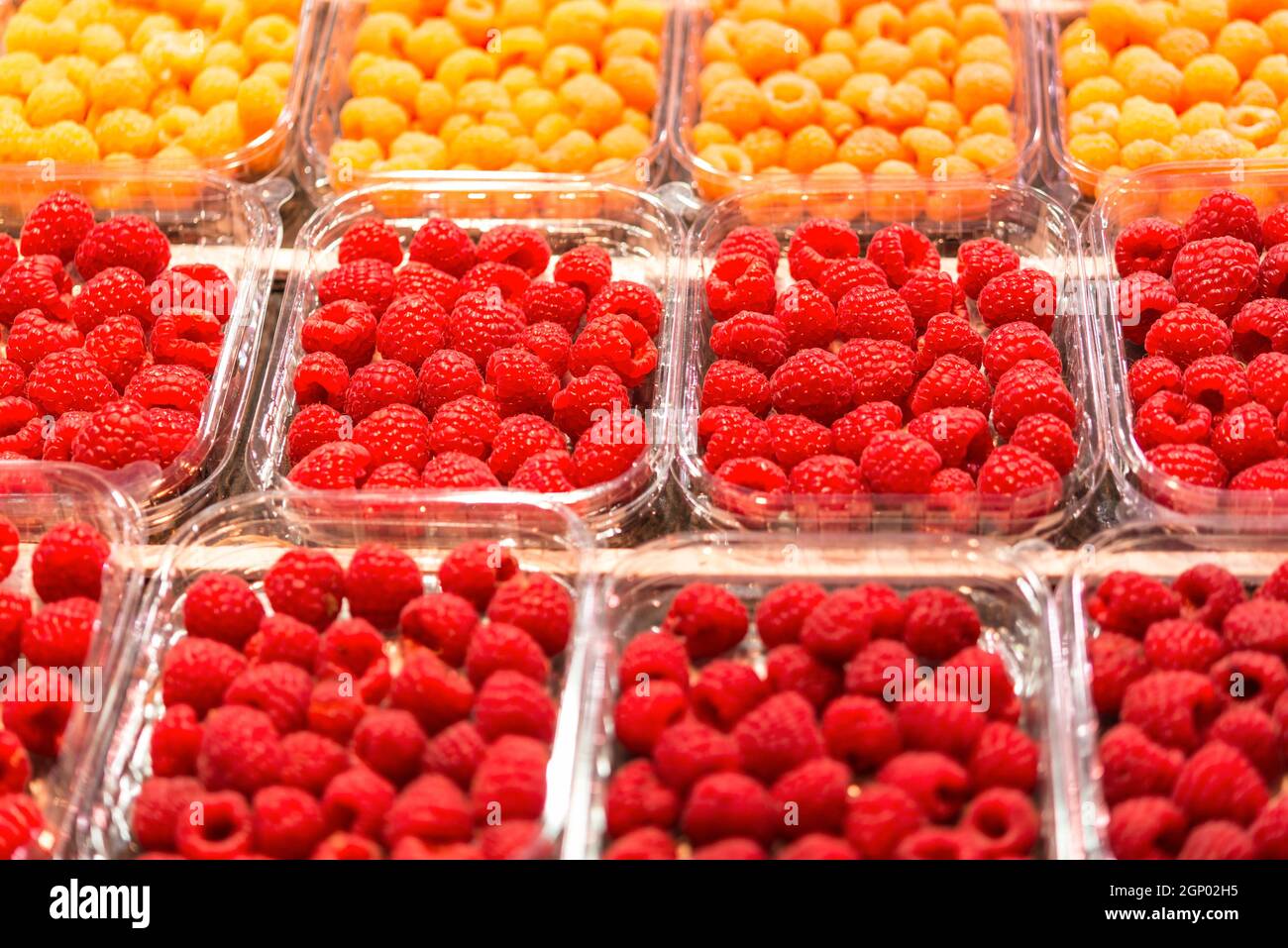 Assortment of fresh rasberries on display at a produce market Stock ...