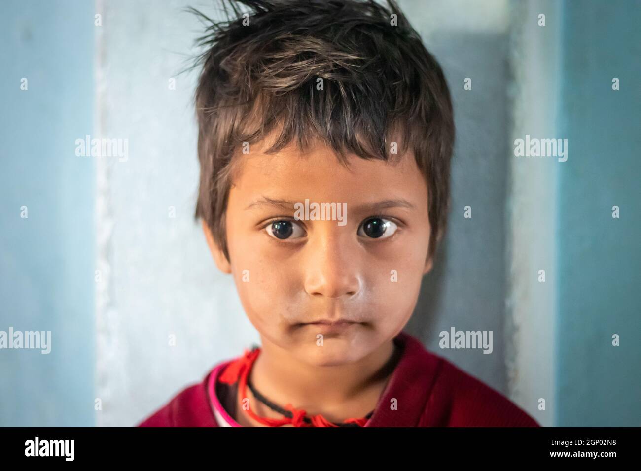 young kid in silence facial expression close up shot at day from flat ...
