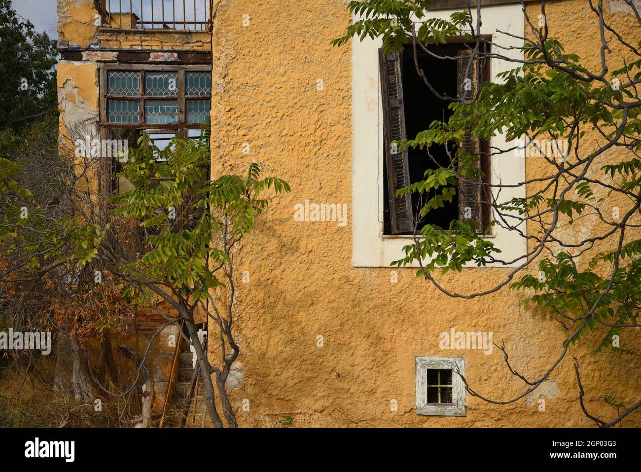 Old abandoned house weathered facade with an aged claystone ochre wall ...