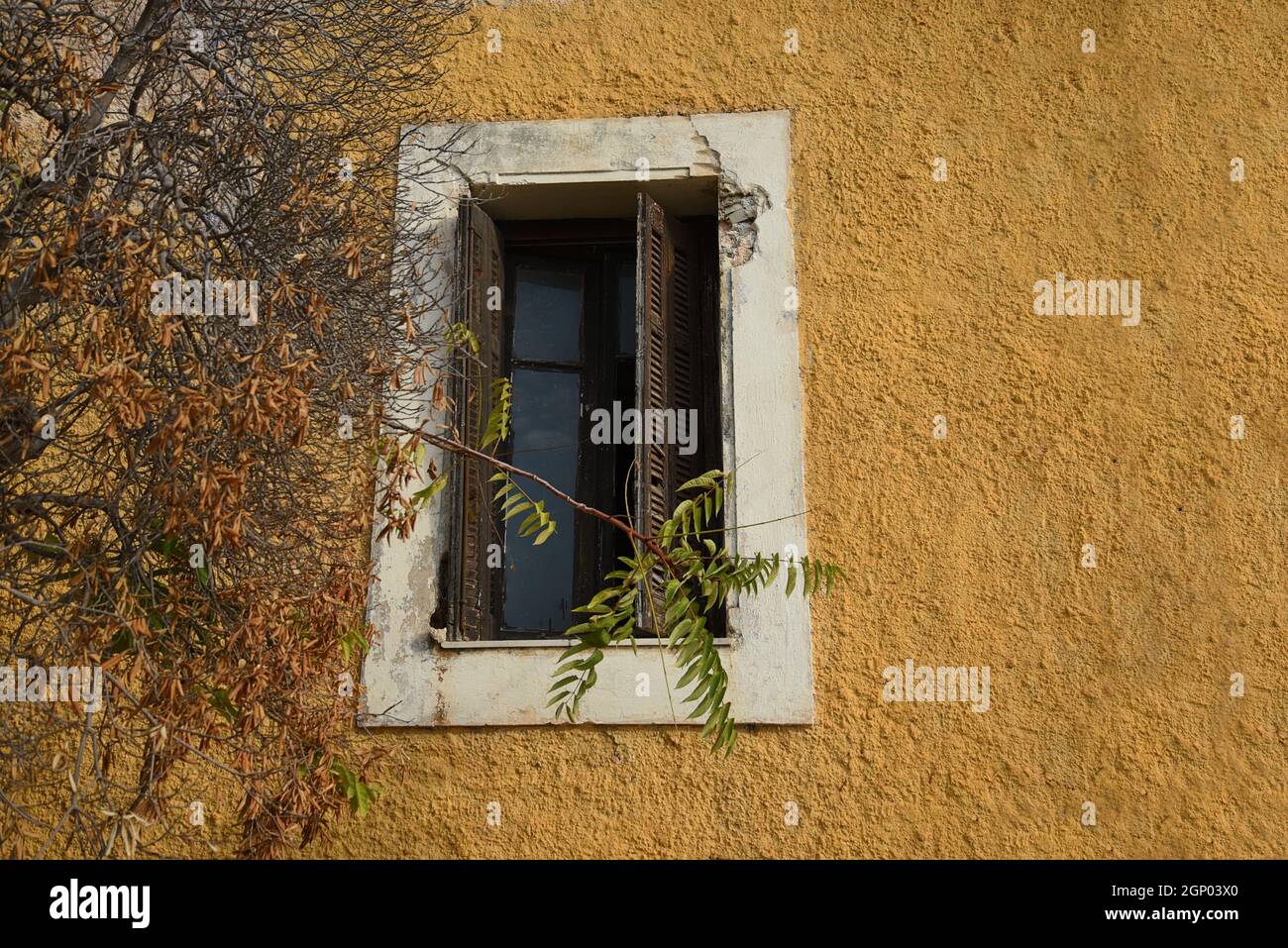 Old abandoned house weathered facade with an aged claystone ochre wall ...