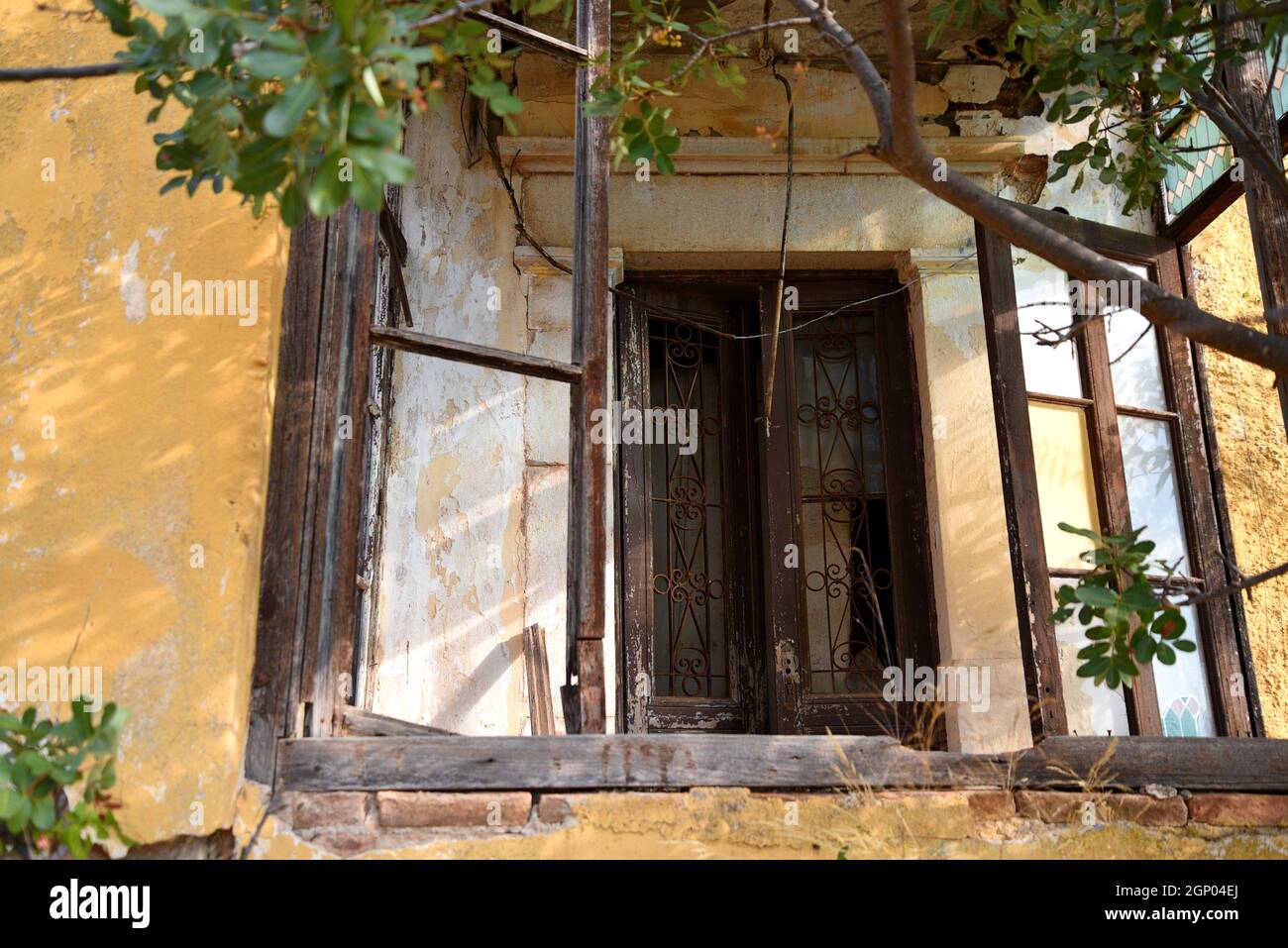 Old abandoned house weathered facade with an aged claystone ochre wall ...