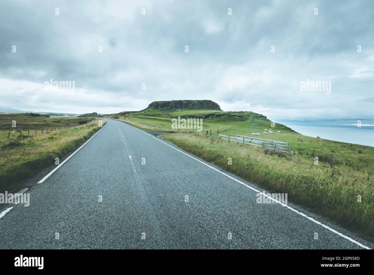 Asphalted, dramatic road in Scotland. Nobody and cloudy sky Stock Photo ...