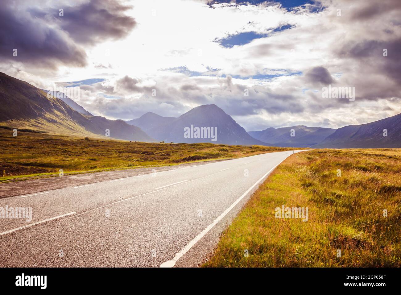 Asphalted, dramatic road in Scotland. Nobody and cloudy sky Stock Photo ...