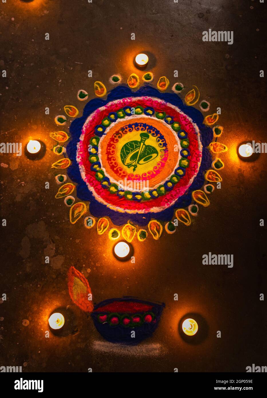 colorful rangoli with lighted candles at festival at night Stock Photo ...