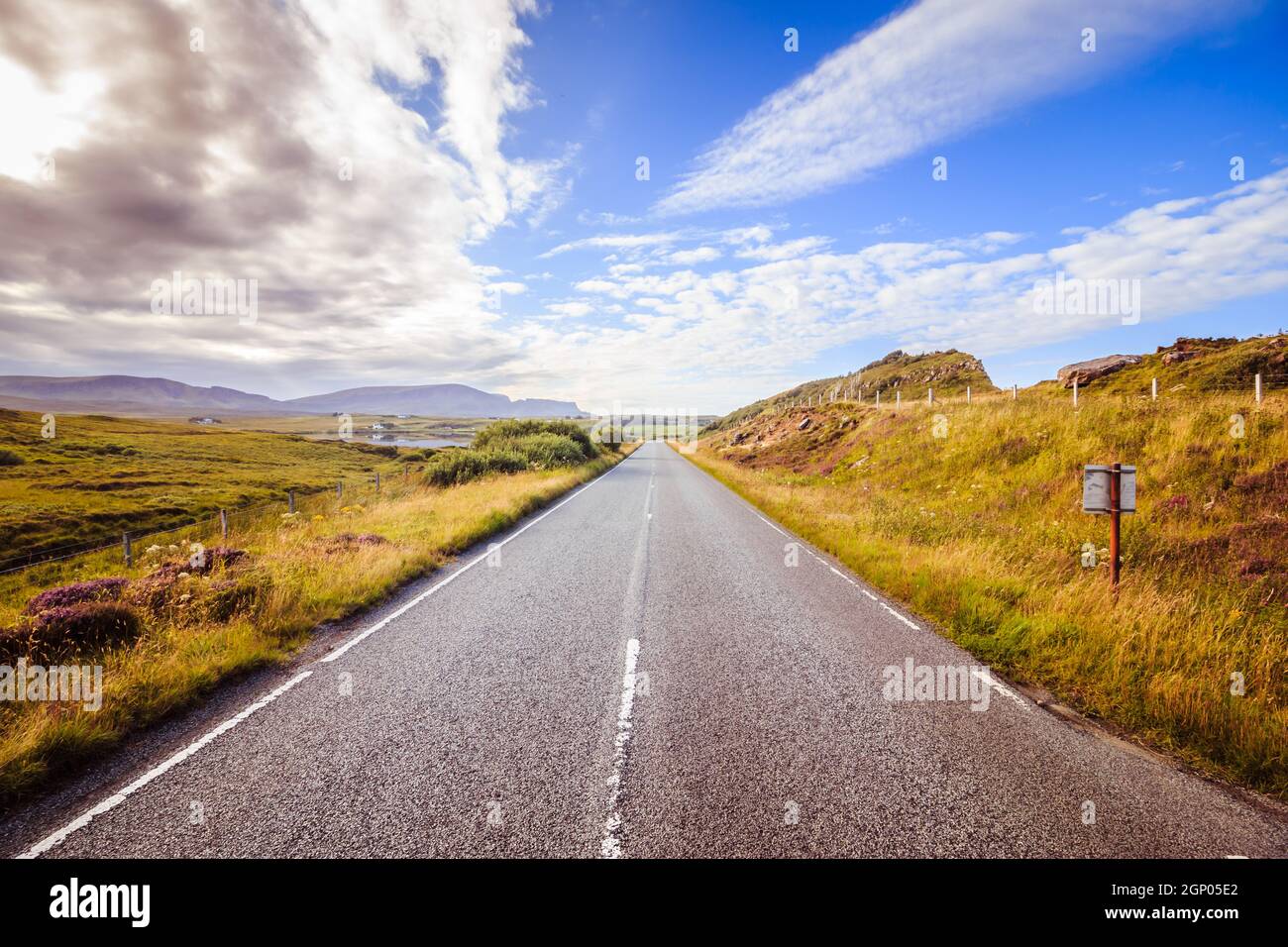 Asphalted, dramatic road in Scotland. Nobody and cloudy sky Stock Photo ...