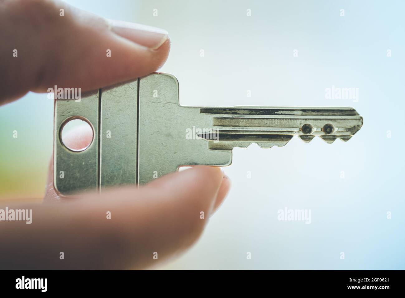 Holding a house key in the hand: New home and property Stock Photo - Alamy