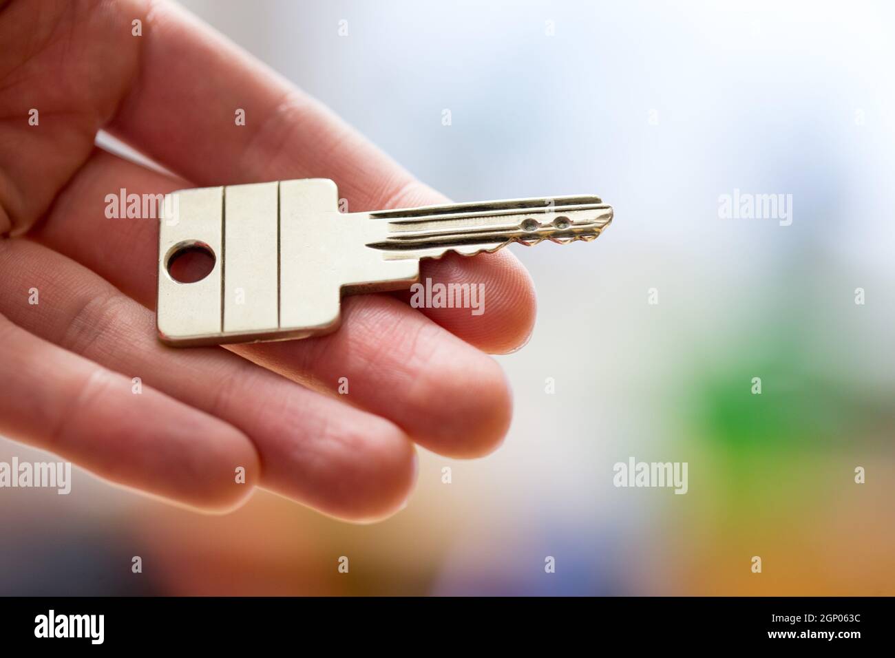 Holding a house key in the hand: New home and property Stock Photo - Alamy