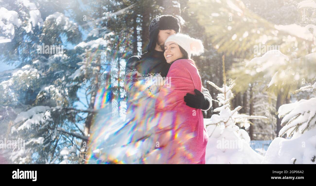 Happy romantic couple standing in snowy background Stock Photo - Alamy