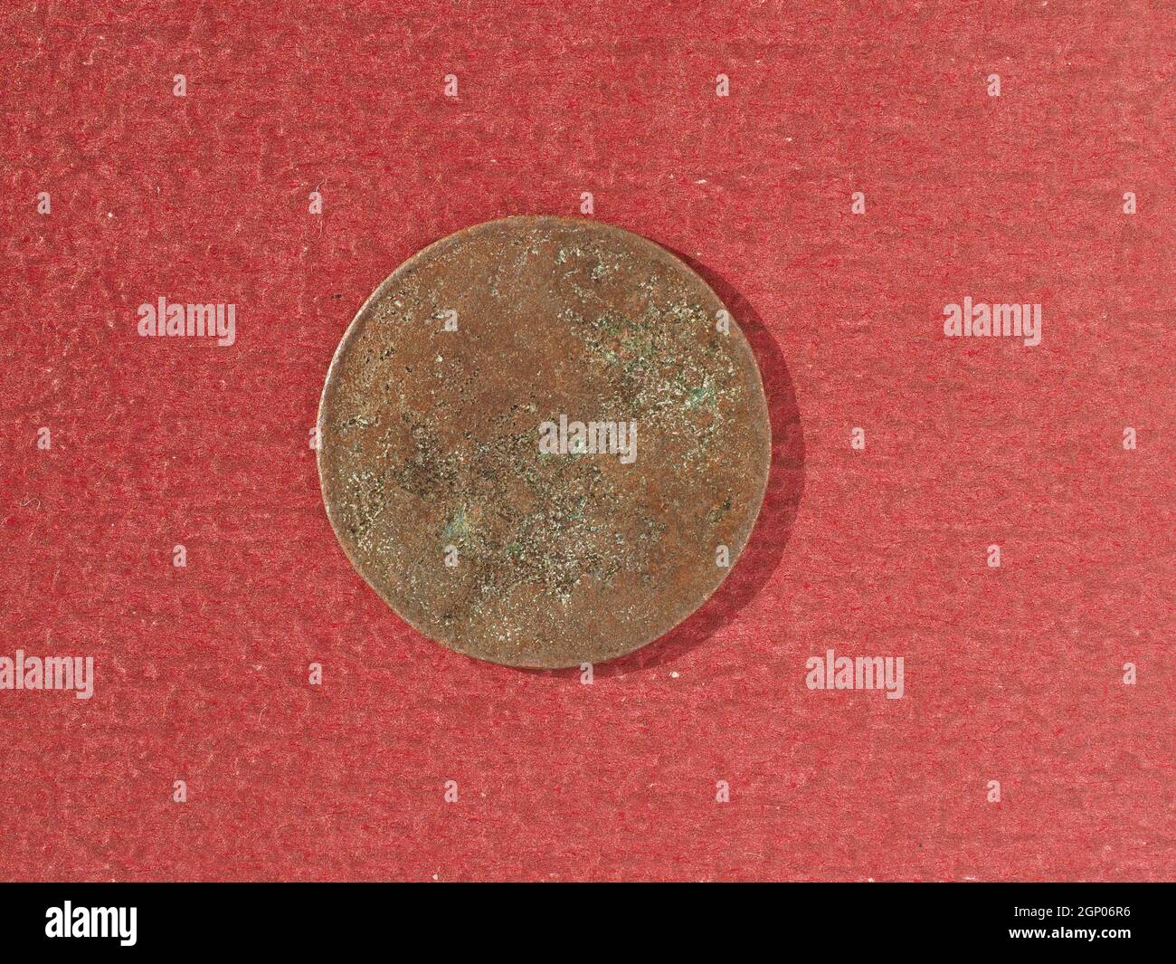 ancient unrecognisable rusted coin over red background Stock Photo - Alamy