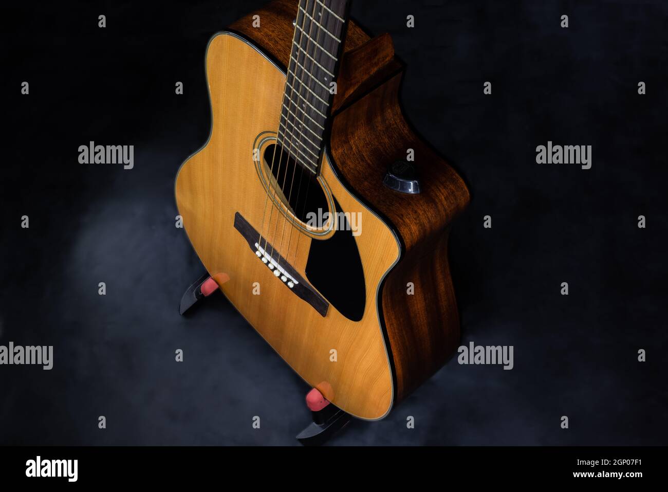 top view on body of classic yellow acoustic guitar with steel strings ...