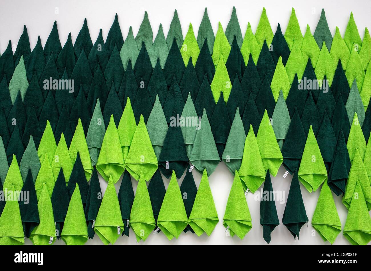 terry towels hanging on the wall in various shades of green Stock Photo ...