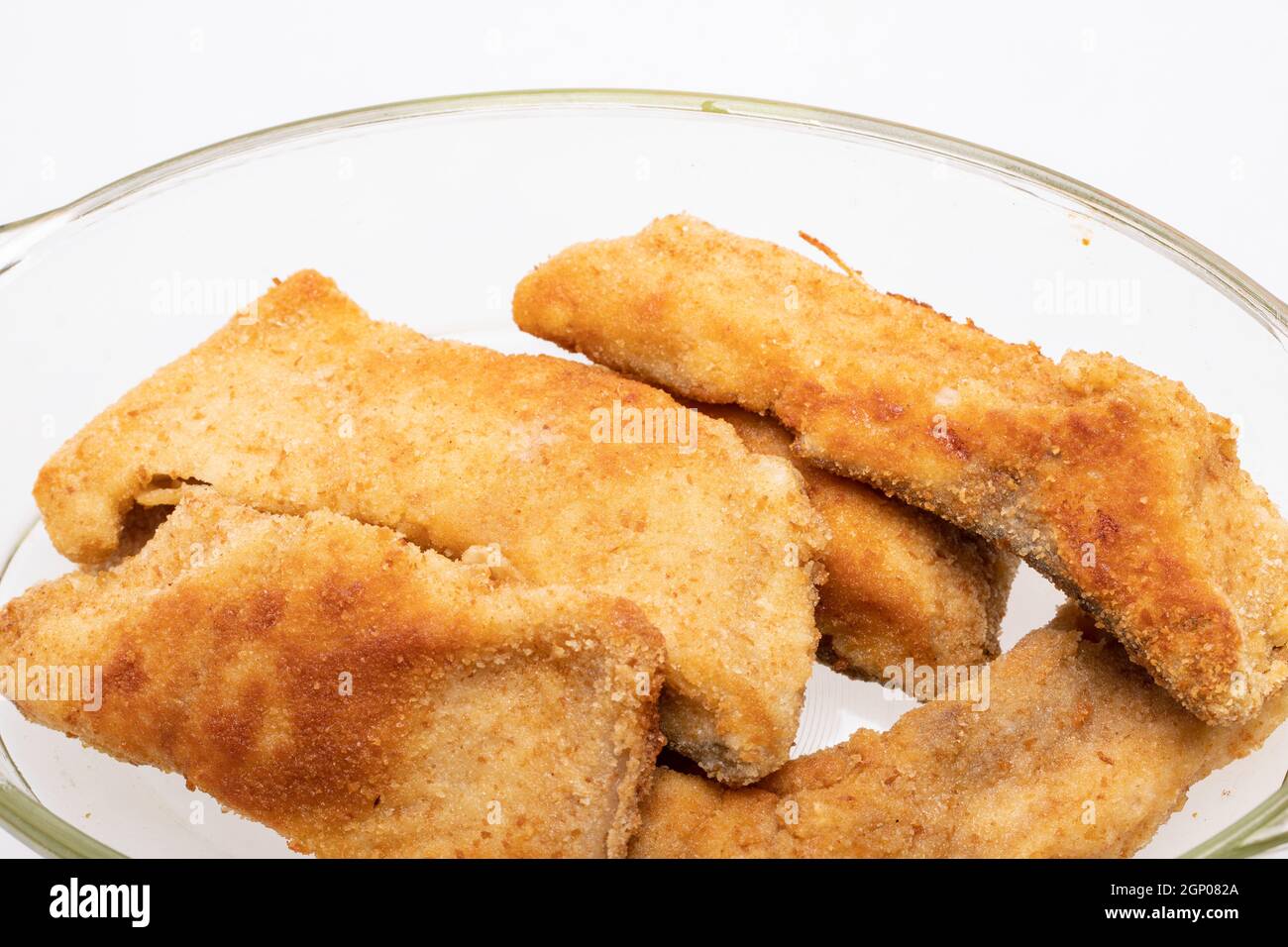 Breaded fish fillets in a glass, heat-resistant dish Stock Photo - Alamy